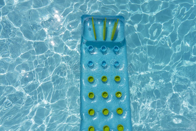Clear Blue Summer Pool Lounger Float on a Rippled Swimming Pool Stock ...