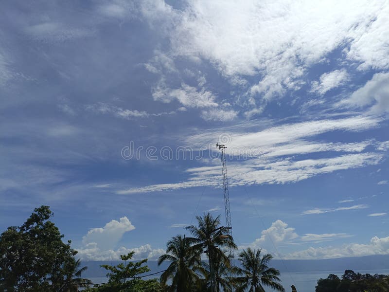 Clear Blue Tropical Sky with Tower and Palm Trees by the Ocean. Stock ...