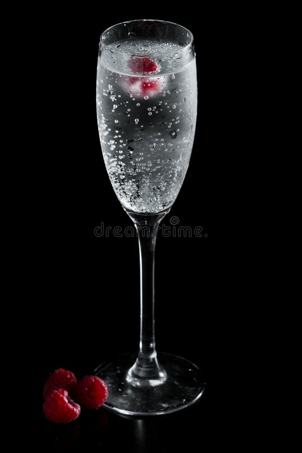 Clear Champagne with a Raspberry Stock Image - Image of black, fizz ...