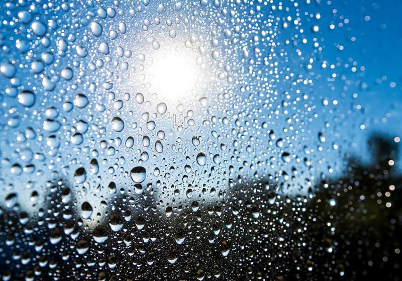 Clear Droplets Scatter Across a Transparent Surface, Catching and ...