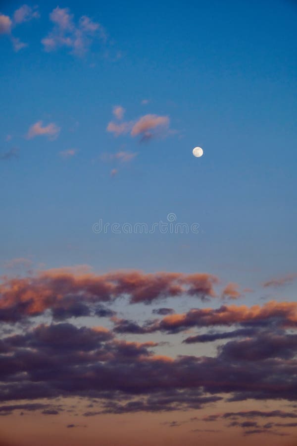 A Clear Evening Sky with the Moon Visible, Surrounded by Dark Clouds ...