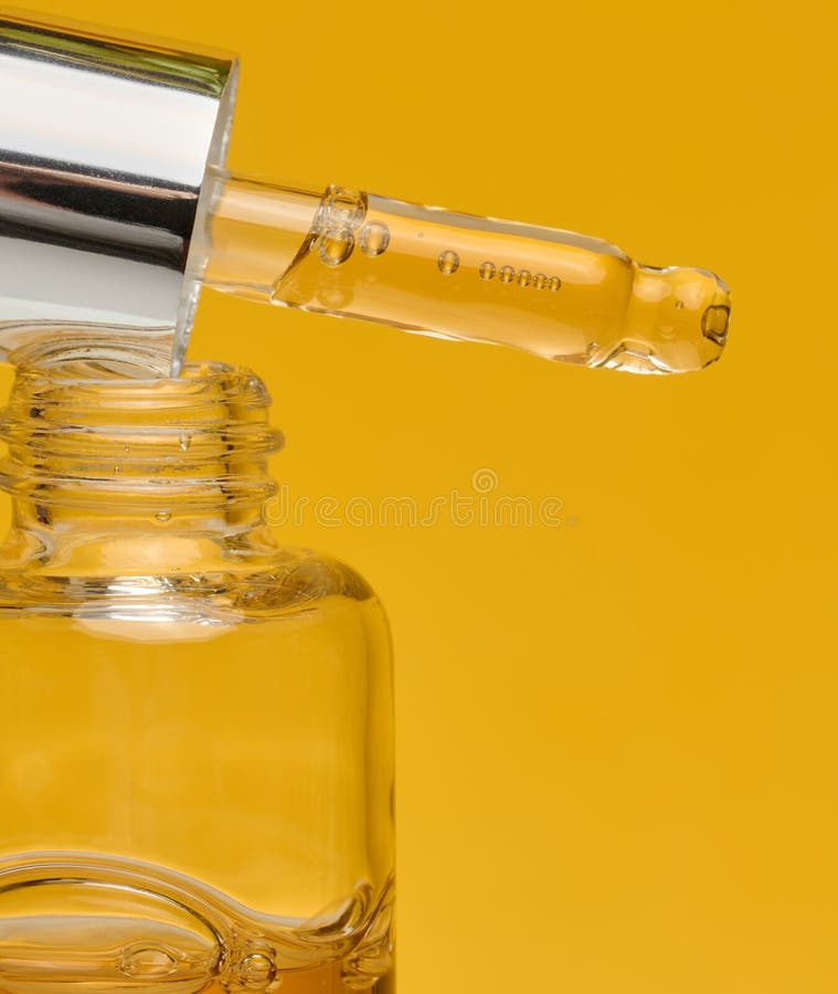 Amber Liquid in Crystal Glass on Blue Background. Stock Photo - Image ...