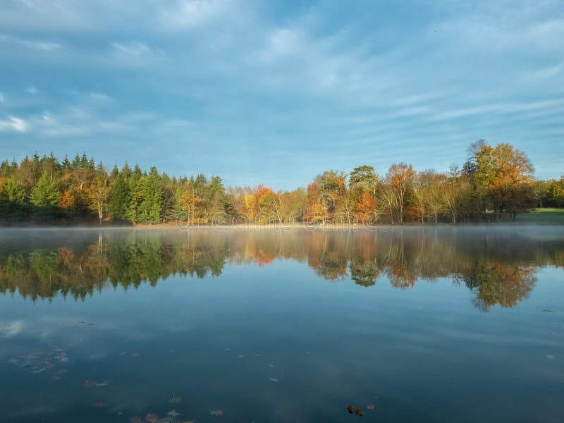 Clear Lake with the Reflection of the Trees and Sky on a Cool Day in ...