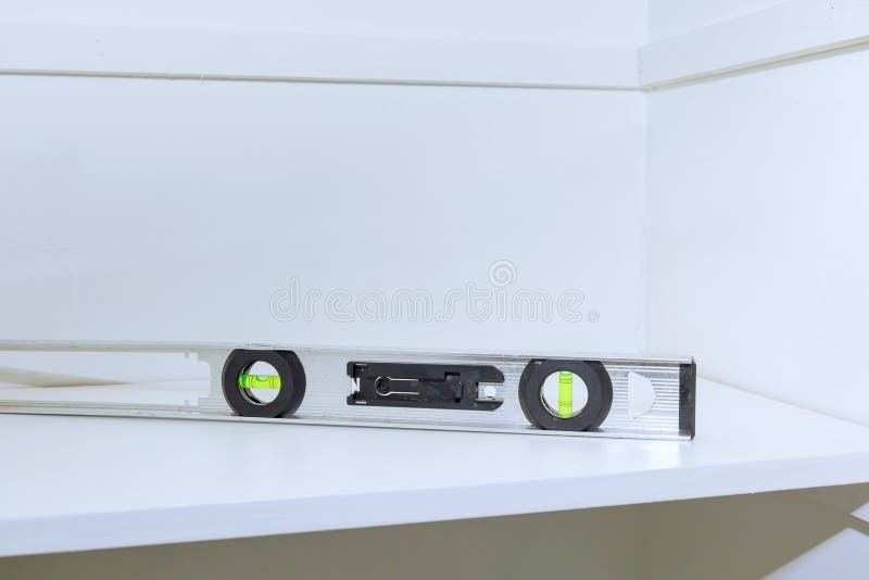Clear Level Rests on Freshly Painted Shelf in Ensuring Perfect ...