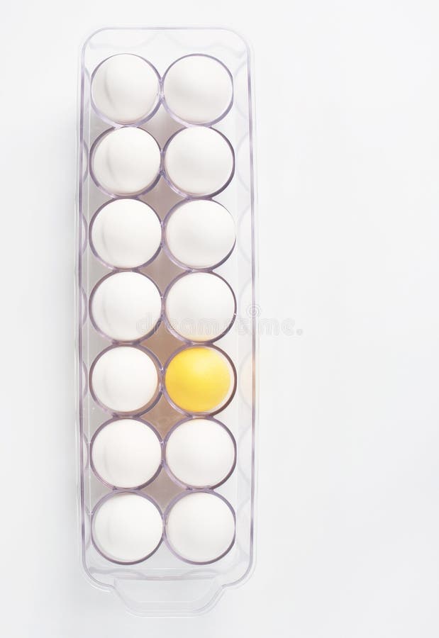 Clear Container of White Eggs and One Yellow Stock Photo - Image of ...