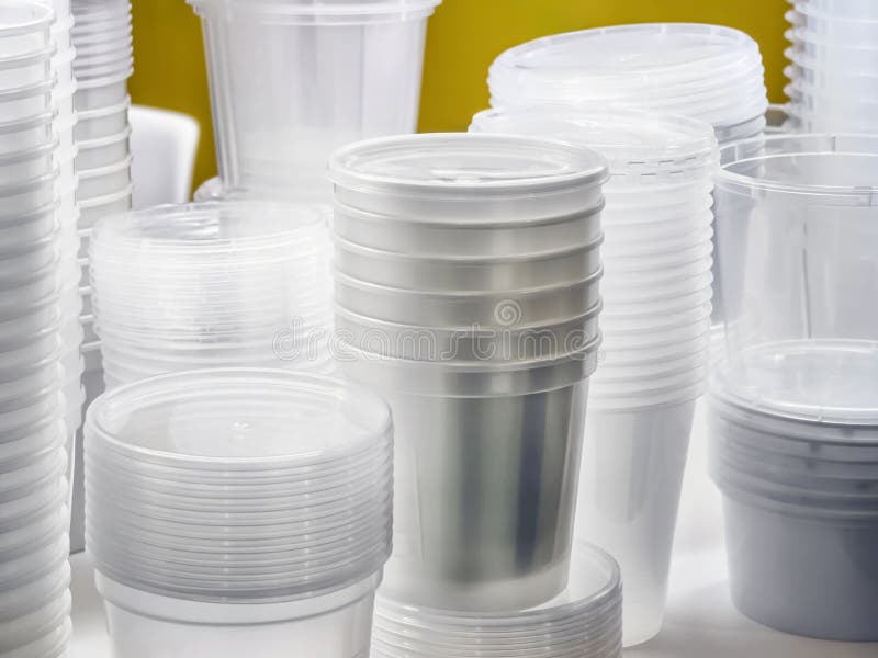 Clear Plastic Cups and Containers Stacked Neatly on a Table in a Bright ...