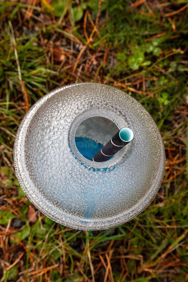 Clear Plastic Drinking Cup with Blue Soda on Ground Outdoors Stock ...