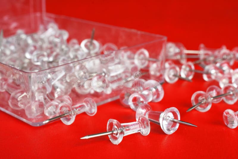 Clear Push Pins on a Red Background Stock Photo - Image of business ...
