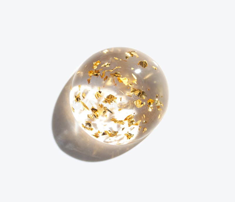 Clear Resin Sphere with Gold Flakes Casting Intricate Shadows in ...