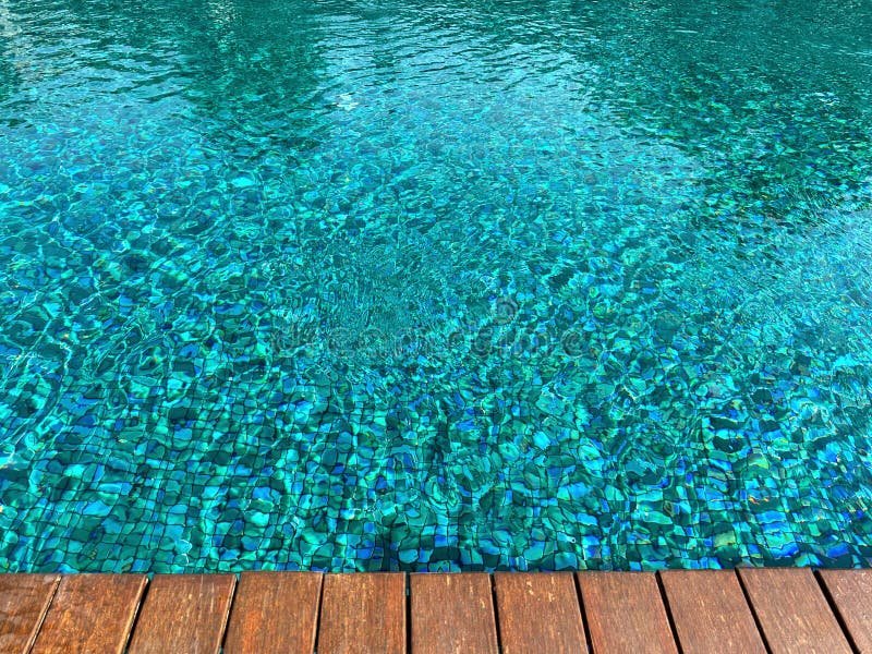 Clear Rippled Water in Swimming Pool and Wooden Deck Outdoors. Space ...