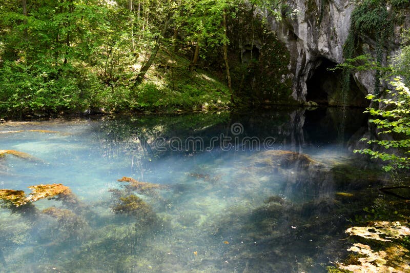 Clear River Emerges from a Small Cave Stock Image - Image of cave ...