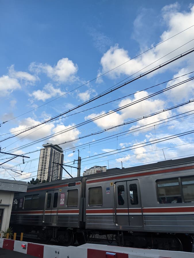Clear Sky with a Few White Clouds Above the Commuter Line Train Stock ...