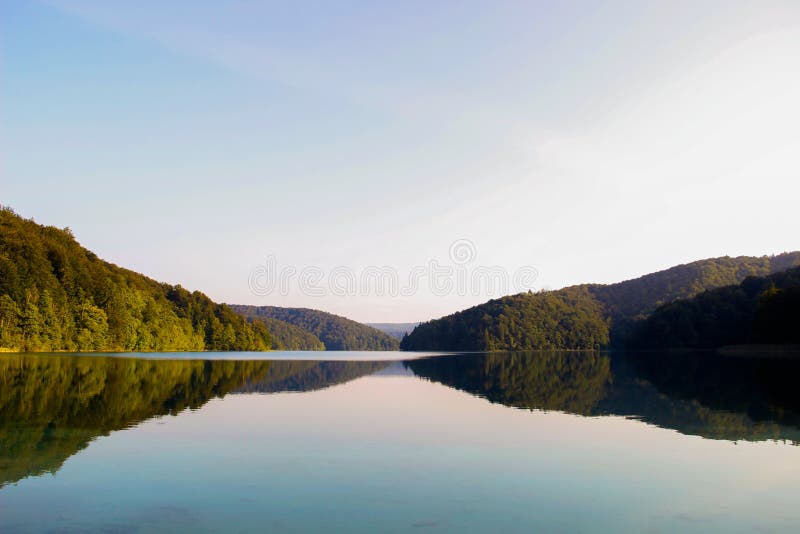 Clear Sky and Water Divided by a Forest Stock Photo - Image of clear ...