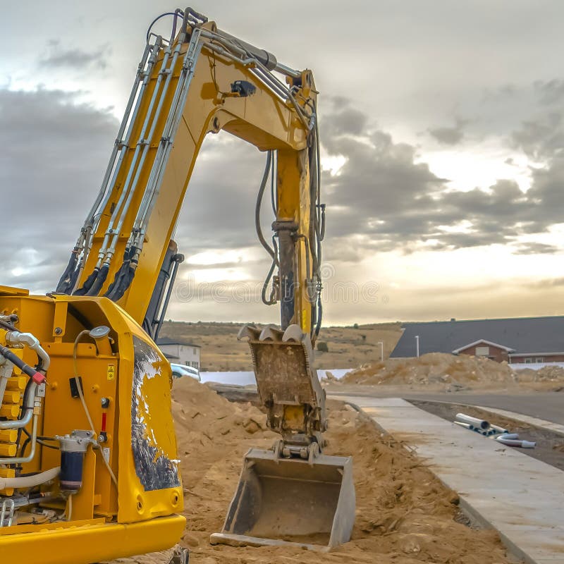 Clear Square Construction Site with an Excavator Against a Dramatic Sky ...