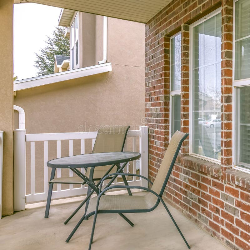 Clear Square Front Porch of a Home with Table and Chairs in Front of ...