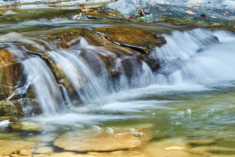Clear Stream Flows Over the Stones Forming a Small Waterfall Stock ...