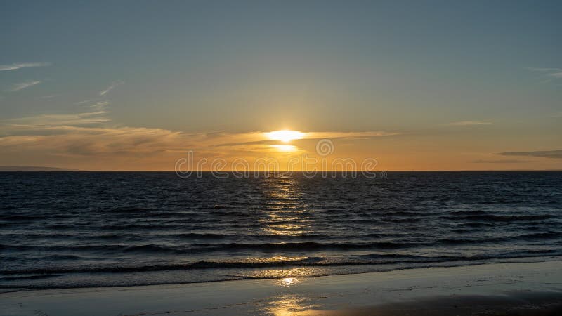 Clear sunset at the beach stock photo. Image of beach - 287997860