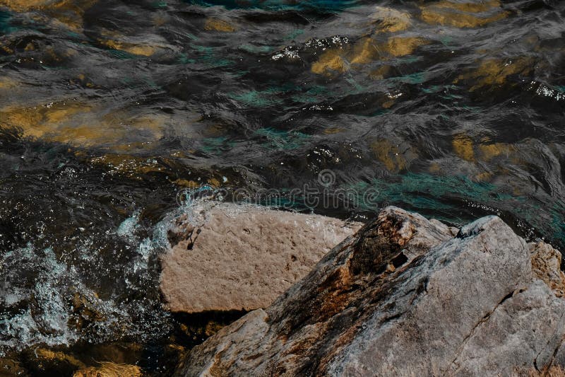 Water flowing into rocks stock image. Image of grunge - 261400615