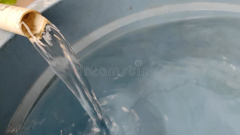 Clear Water Flows Gracefully from the PVC Pipe into the Basin Stock ...