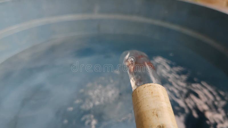 Clear Water Flows Gracefully from the PVC Pipe into the Basin Stock ...