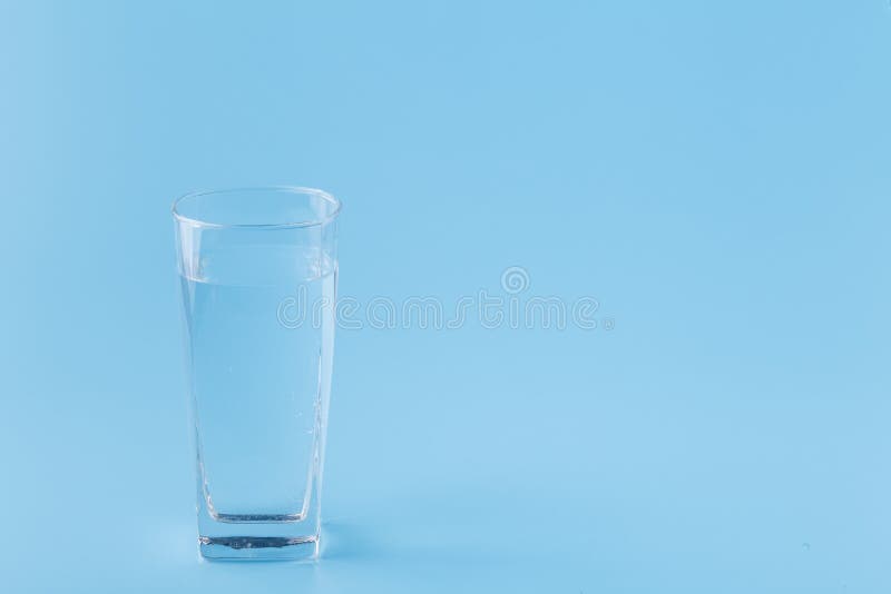 Clear Water in Glass Cup on Blue Stock Image - Image of motion, natural ...