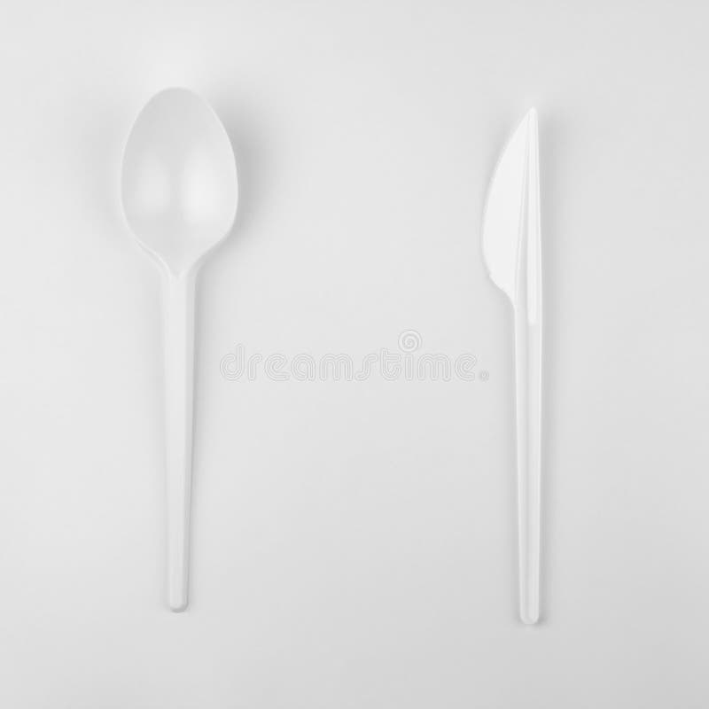 Clean White Plastic Crossed Spoon and Knife on White Background with ...