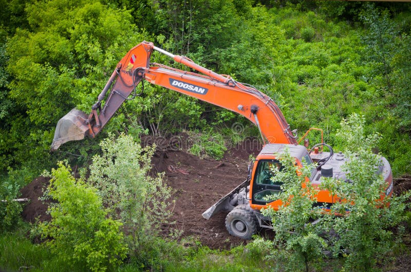 Clearing Underbrush with the Excavator. Editorial Photography - Image ...
