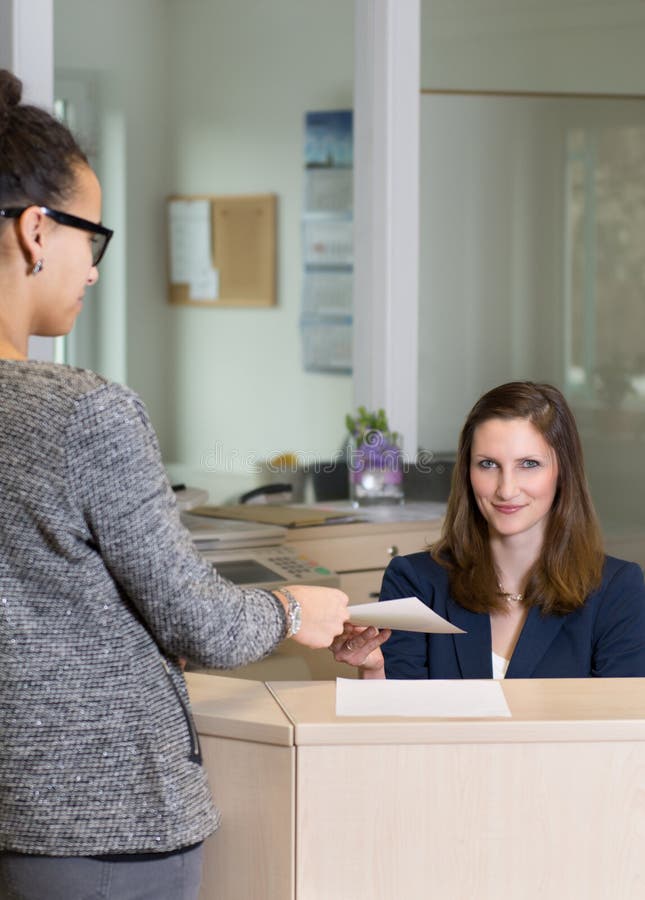 Clerk is Handing Over a Document To a Customer Stock Photo - Image of ...