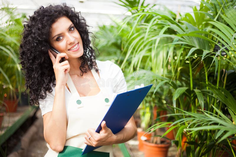 Clerk Talking on the Phone in a Greenhouse Stock Photo - Image of order ...