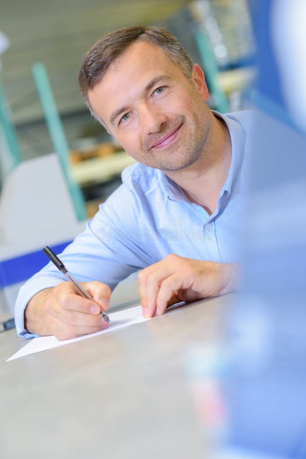 Clerk writing while posing stock photo. Image of looking - 117896380