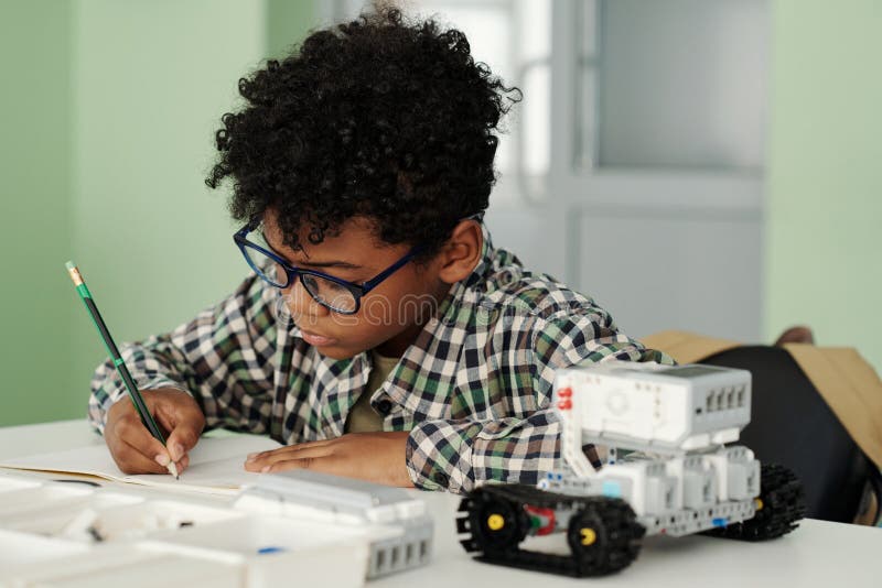 Clever and Diligent Boy with Pencil Making Notes or Drawing Sketch in ...