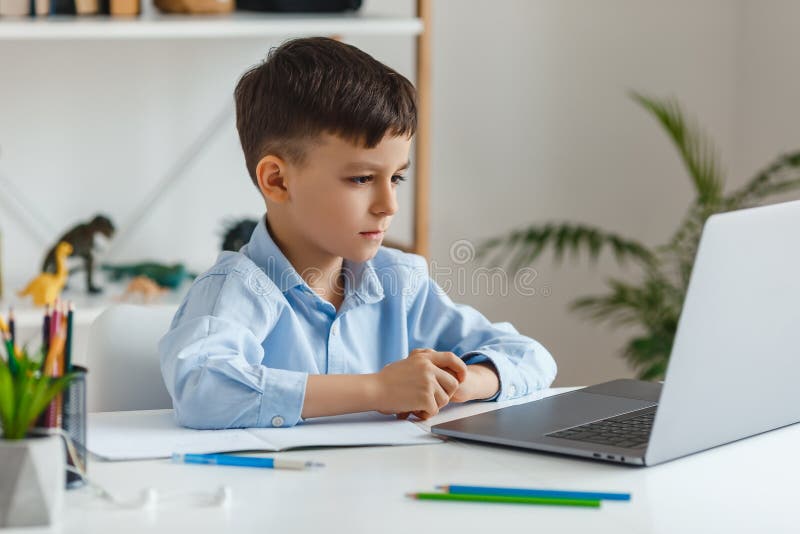 Clever Kid Doing Homework Using Laptop and Internet Stock Photo - Image ...