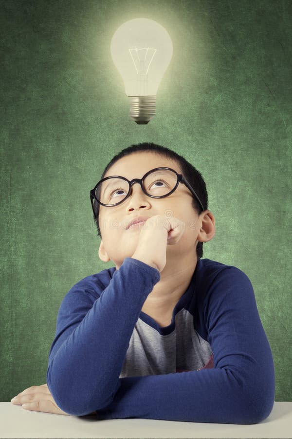 Child Thinks Inspiration Under Bright Light Bulb Stock Image - Image of ...