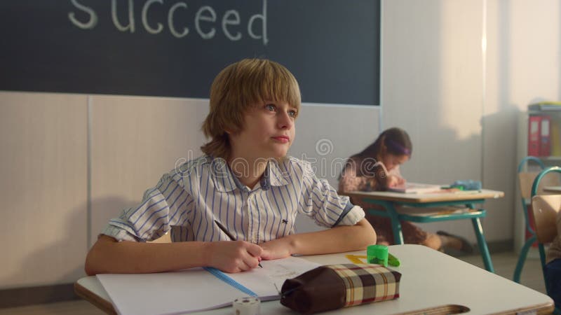 Schoolboy Making Notes in Notebook. Smart Boy Writing in Exercise Book ...