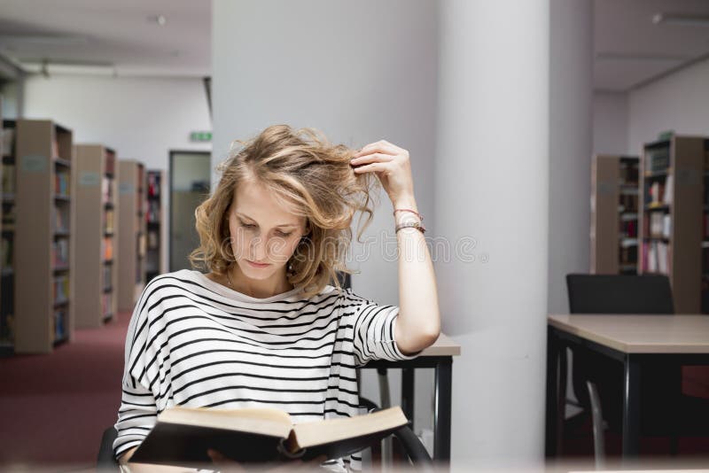 Clever Student with Open Book Reading it in College Library Stock Image ...