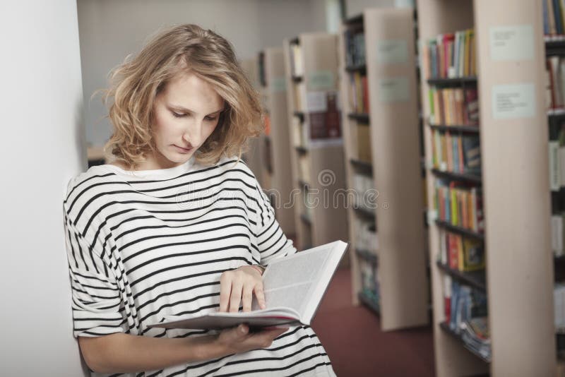 Clever Student with Open Book Reading it in College Library Stock Image ...
