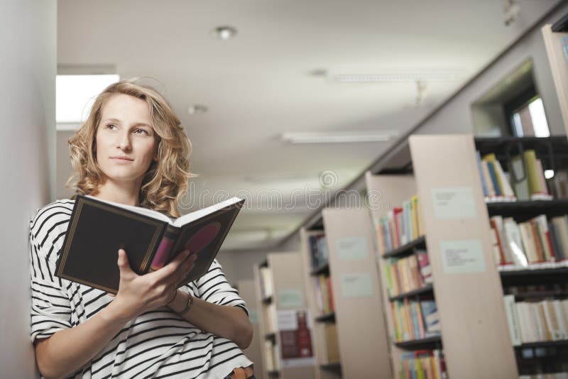 Clever Student with Open Book Reading it in College Library Stock Image ...