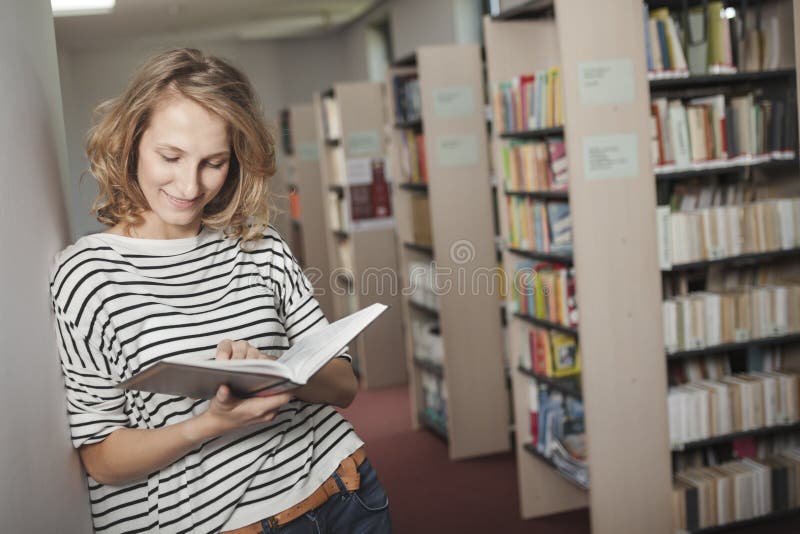 Clever Student with Open Book Reading it in College Library Stock Image ...