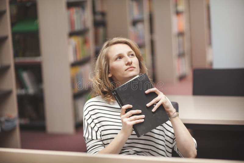 Clever Student with Open Book Reading it in College Library Stock Image ...