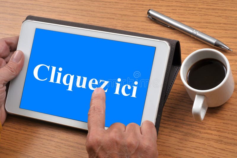 Click Here Written in French on a Tablet Stock Photo - Image of ...