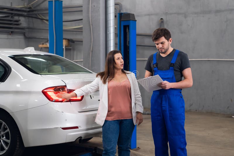 A Client Asks a Worker about a Car Repair Stock Photo - Image of order ...