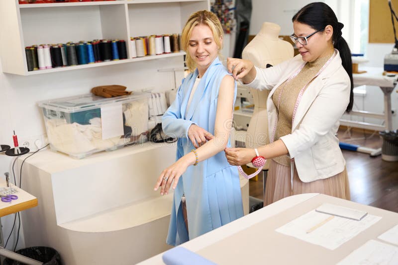 Client is Being Fitted by Experienced Craftswoman in Sewing Studio ...