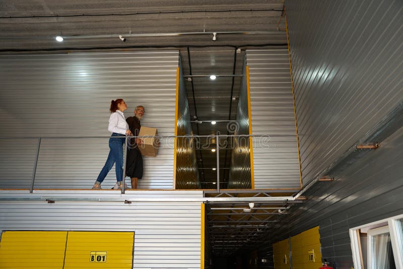 Client with a Box and a Manager Walk through Warehouse Stock Image ...