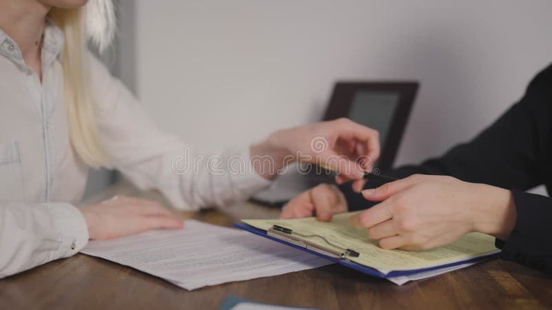 A Client in the Office Signs a Document with a Pen. Signing of the ...