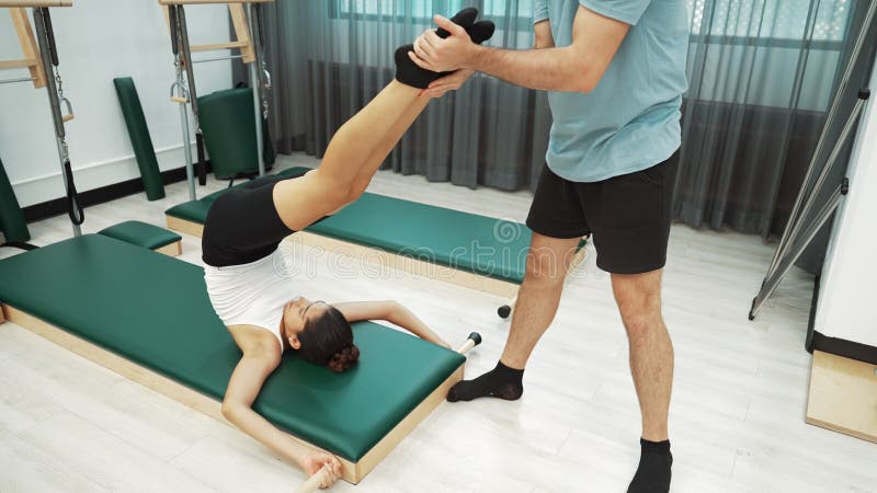 Client Practicing Leg Raises with Core Engagement during Session ...