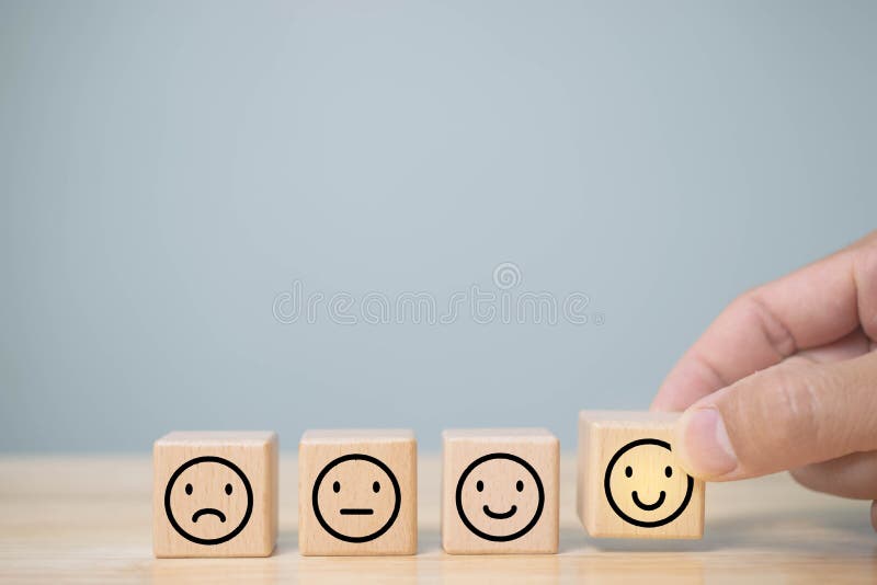 The Client`s Hand Picked the Smile Face Symbol on Wooden Blocks, the ... The Client`s Hand Picked the Smile Face Symbol on Wooden Blocks, the ...