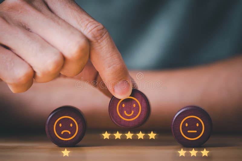 The Client`s Hand Picked the Smile Face Symbol on Wooden Blocks, the ... The Client`s Hand Picked the Smile Face Symbol on Wooden Blocks, the ...