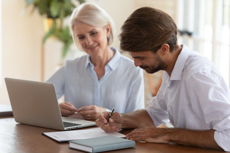 Client Signing Contract with Middle Aged Manager after Successful ...