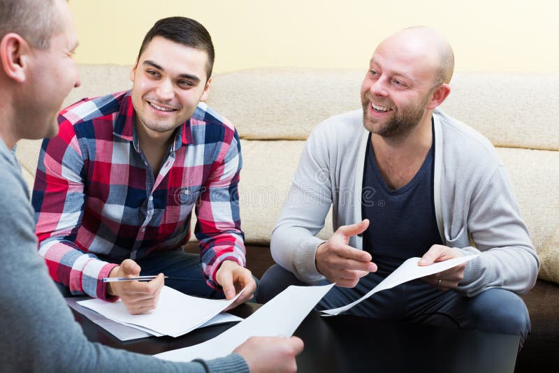 Clients Sitting with Papers and Smiling Stock Image - Image of ...