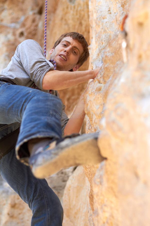 Cliff Climber. Portrait of a Young Rock Climber on a Climbing Rockface ...